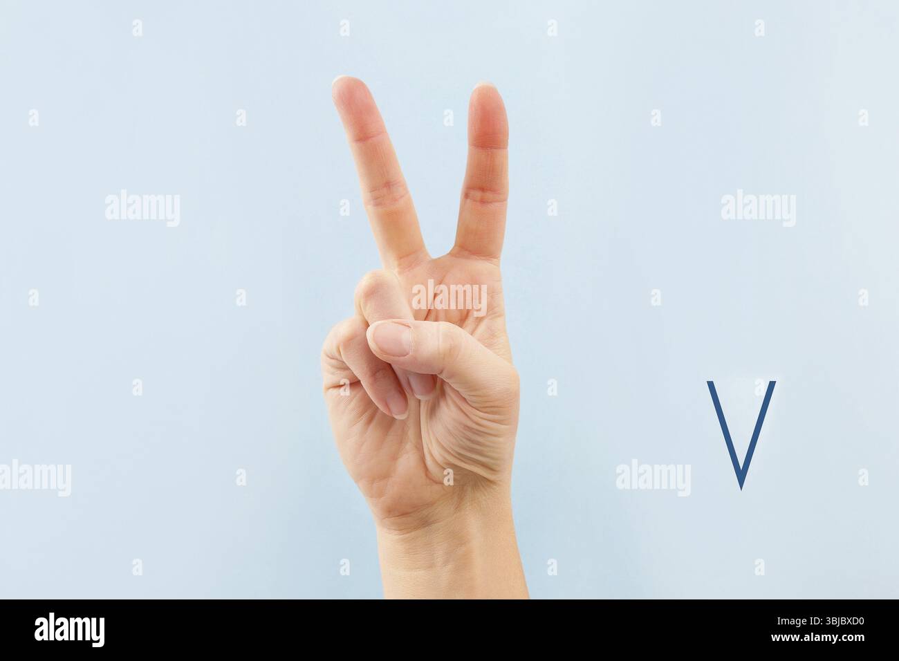 American sign language. Female hand showing letter V isolated on blue ...