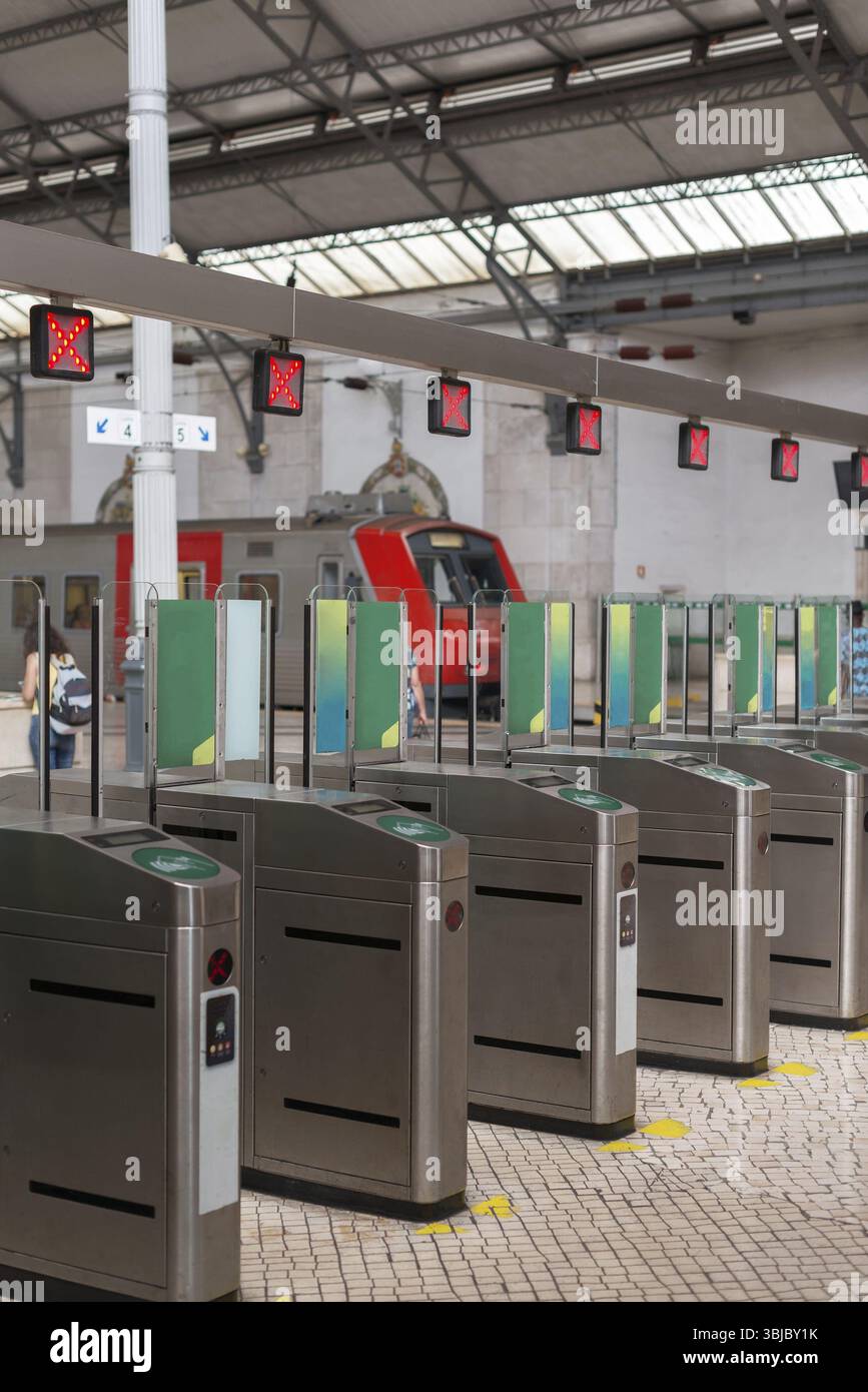 Electronic turnstiles in train station terminal Stock Photo - Alamy