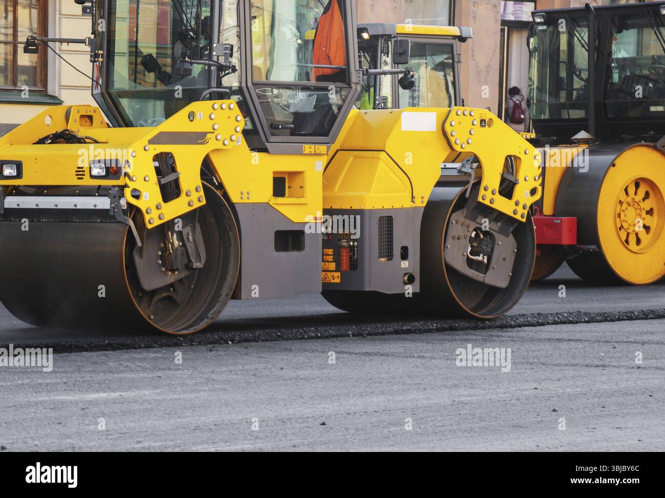 Road re-construction. Road rollers stacking hot asphalt Stock Photo - Alamy