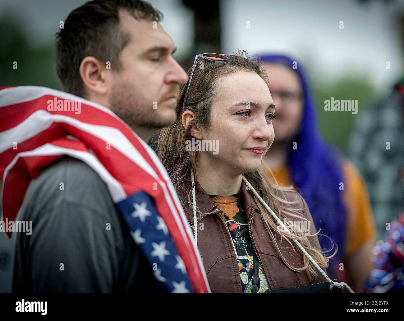 Ashley Ruhland, right, cries alongside Cole Hartson as they join ...