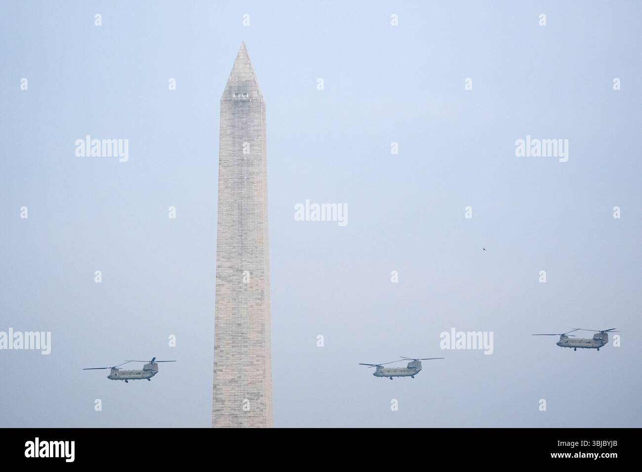 U.S. Army CH-47 Chinook helicopters perform a flyover during an event ...