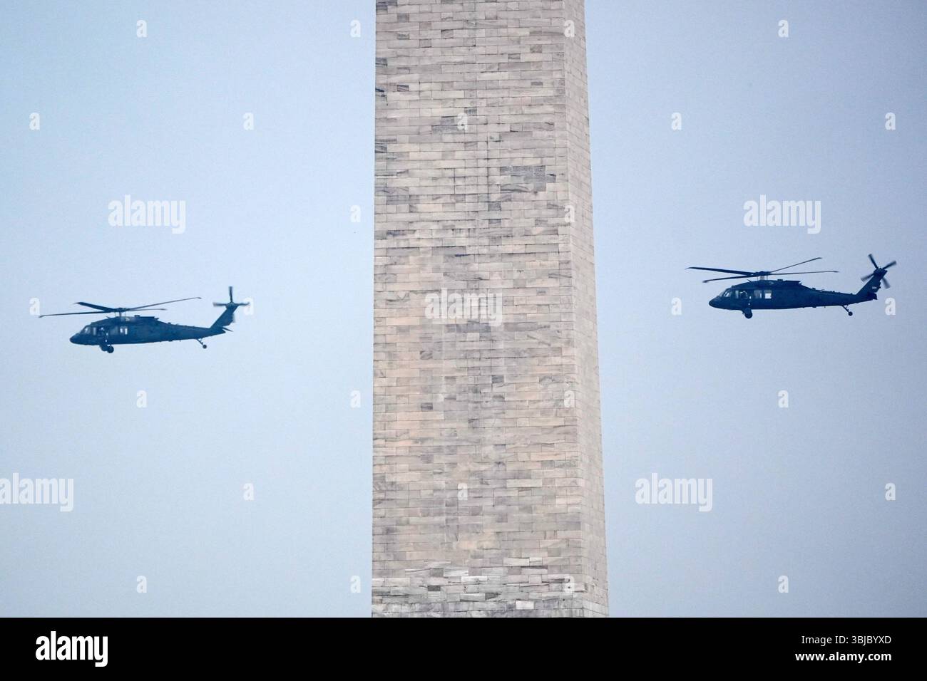 U.S. Army UH-60M Black Hawk helicopters perform a flyover during an ...