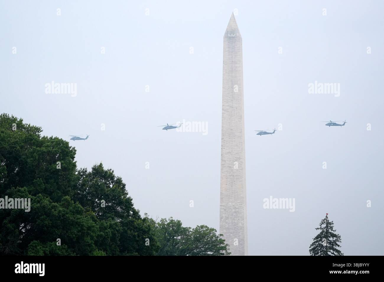 U.S. Army UH-60M Black Hawk helicopters perform a flyover during an ...
