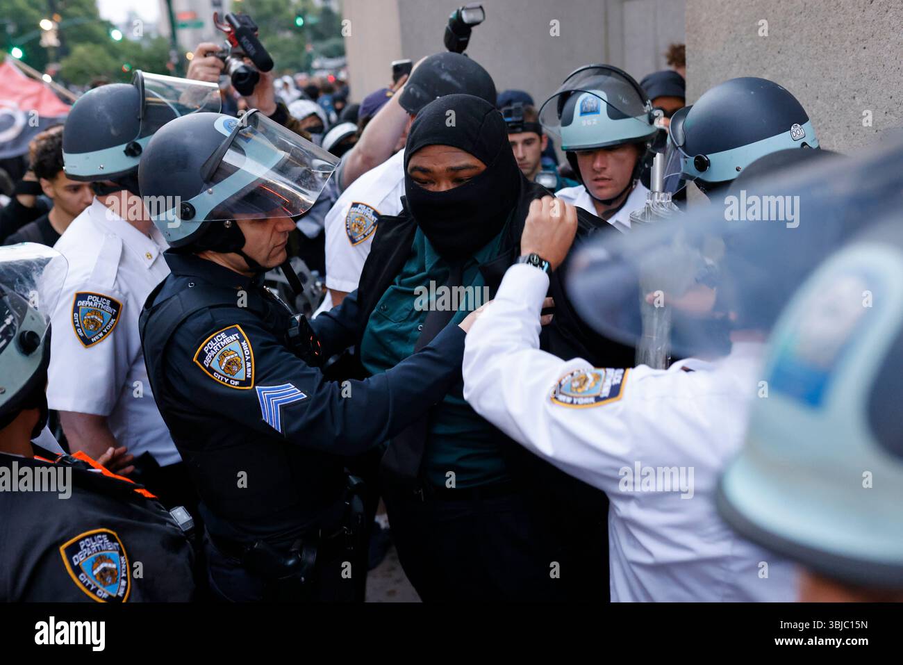 New York Police officers arrest a man for allegedly assaulting ...
