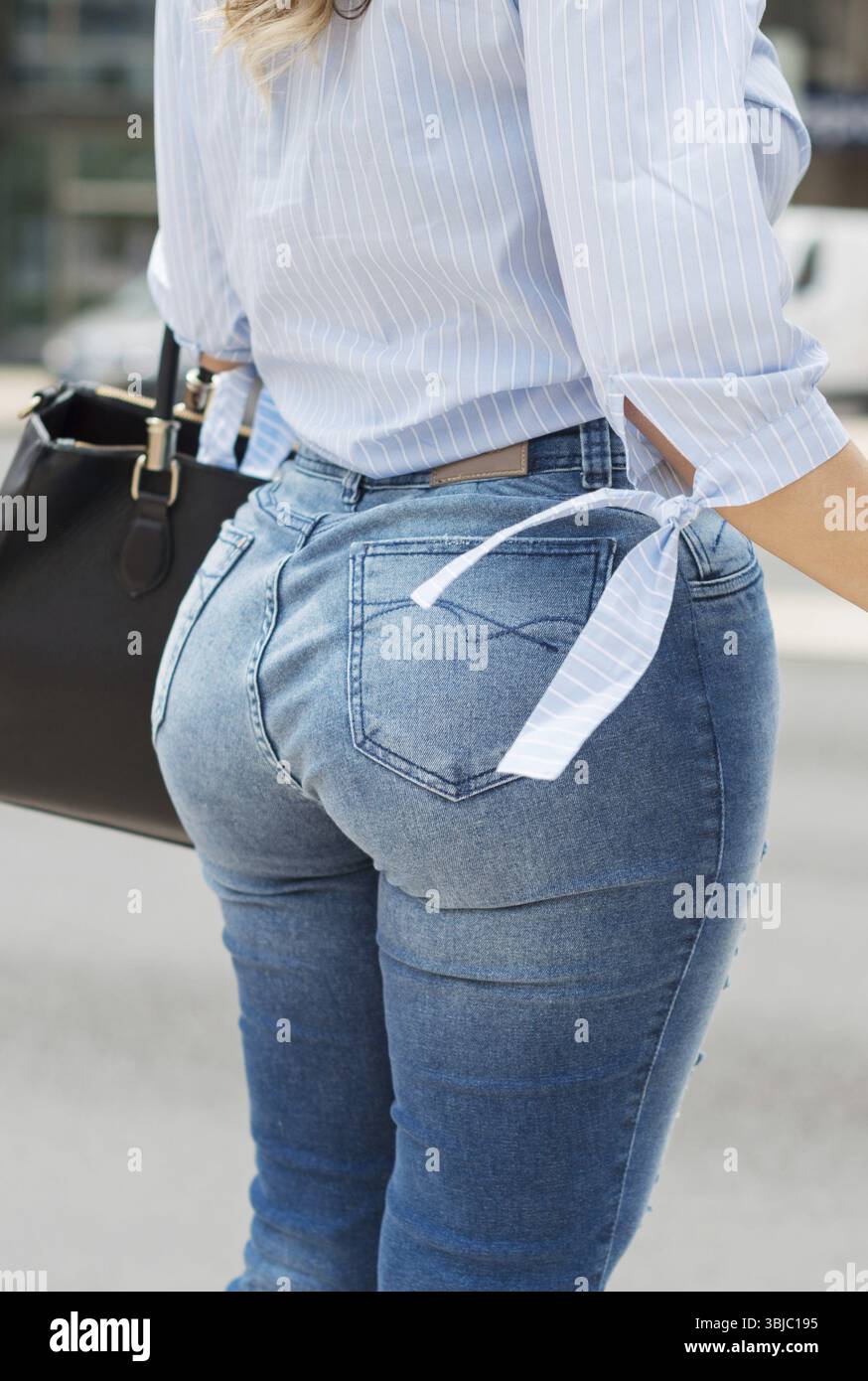 Woman with big artificial buttocks on the street Stock Photo - Alamy
