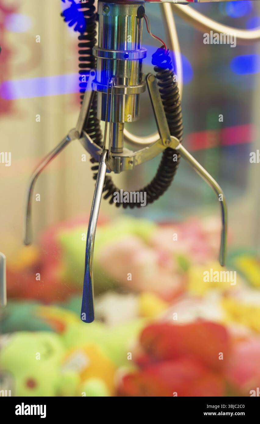 Mechanical claw game machine. Close-up view Stock Photo - Alamy
