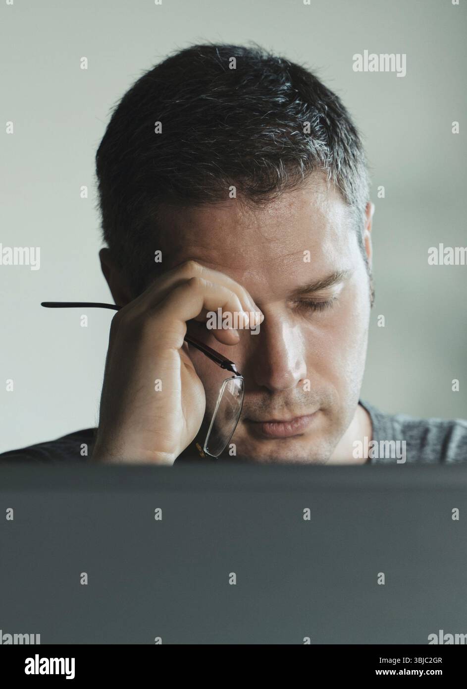 Tired man with eyes fatigue at work Stock Photo - Alamy