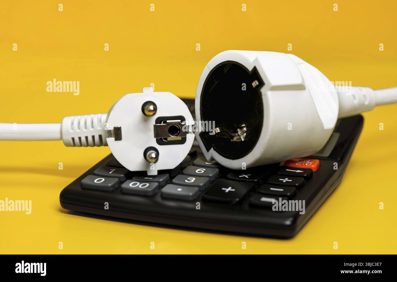 Electricity growth concept. Calculator and AC power plug Stock Photo ...