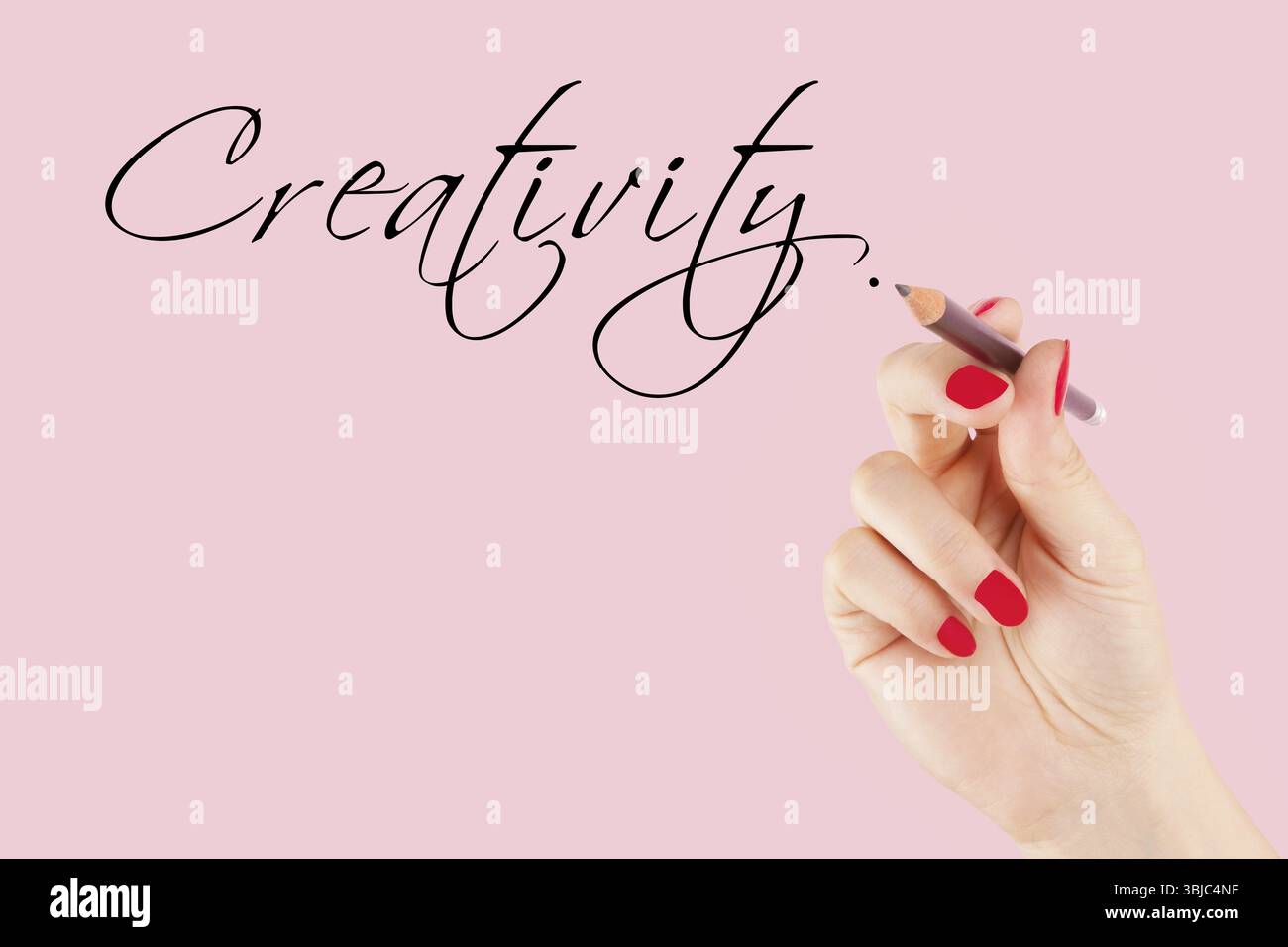 Creative industries. Female hand with pencil writing the word ...
