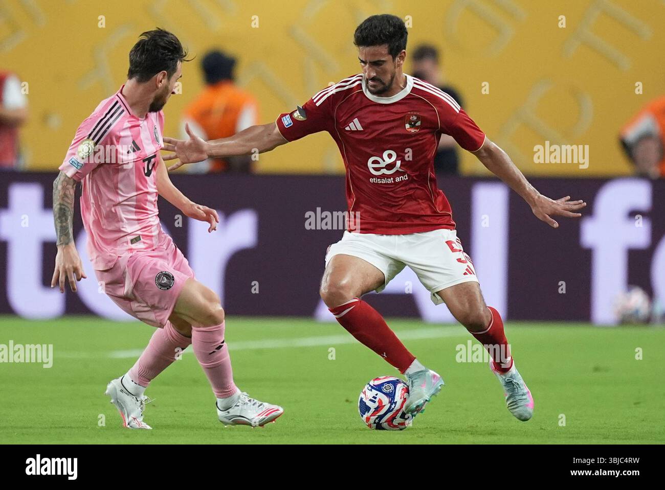 Inter Miami's Lionel Messi, left, challenges Al Ahly's Mohamed Ali Ben Romdhane during the Club ...