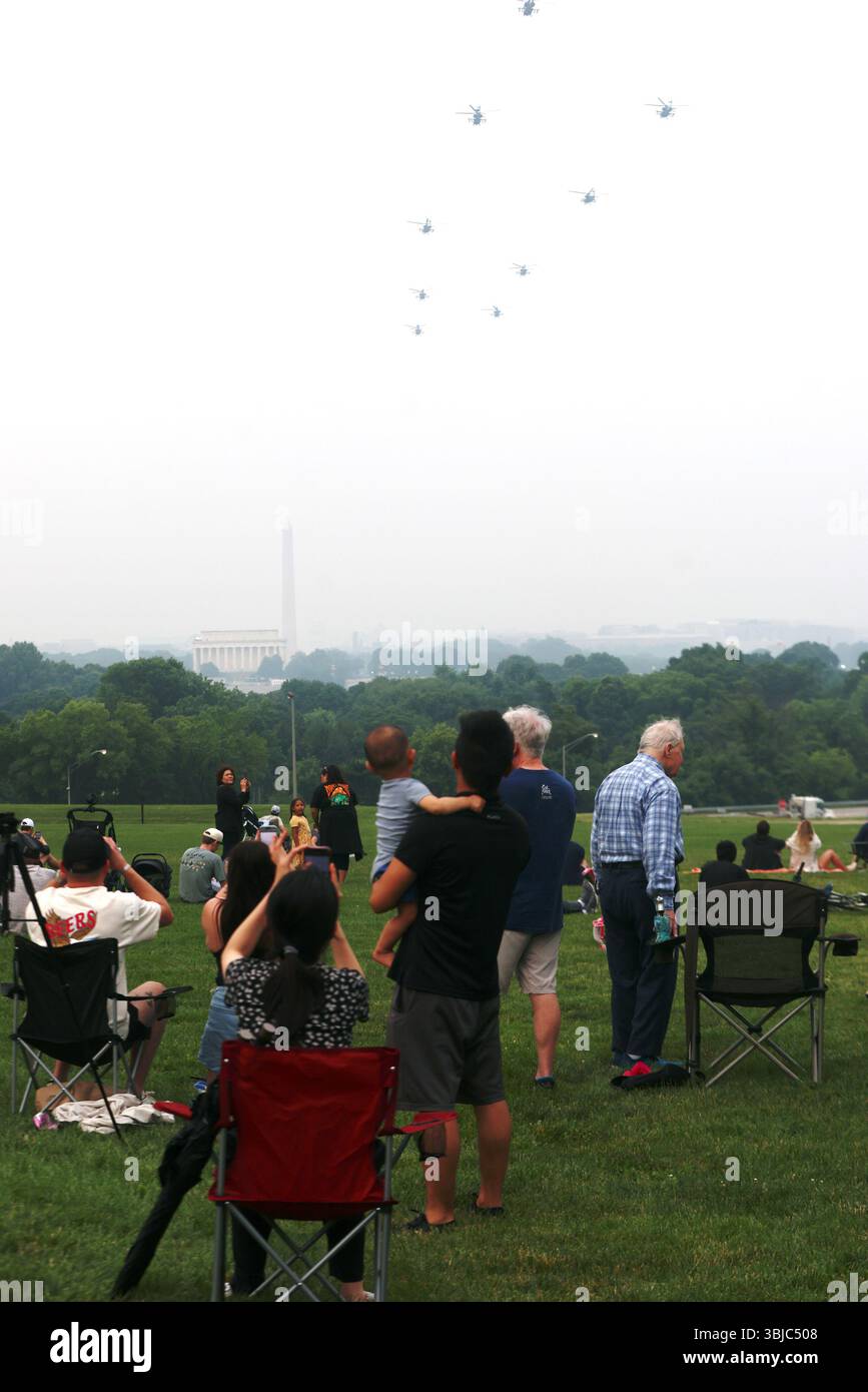 Washington, DC, USA. 14th June, 2025. Onlookers watch as the US Army ...