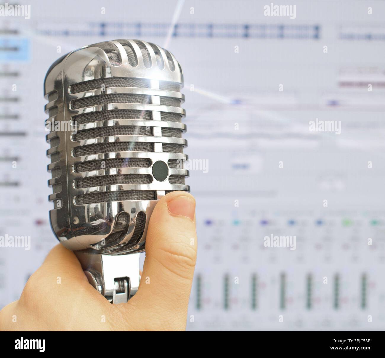 Hand holding retro microphone over recording software background Stock ...