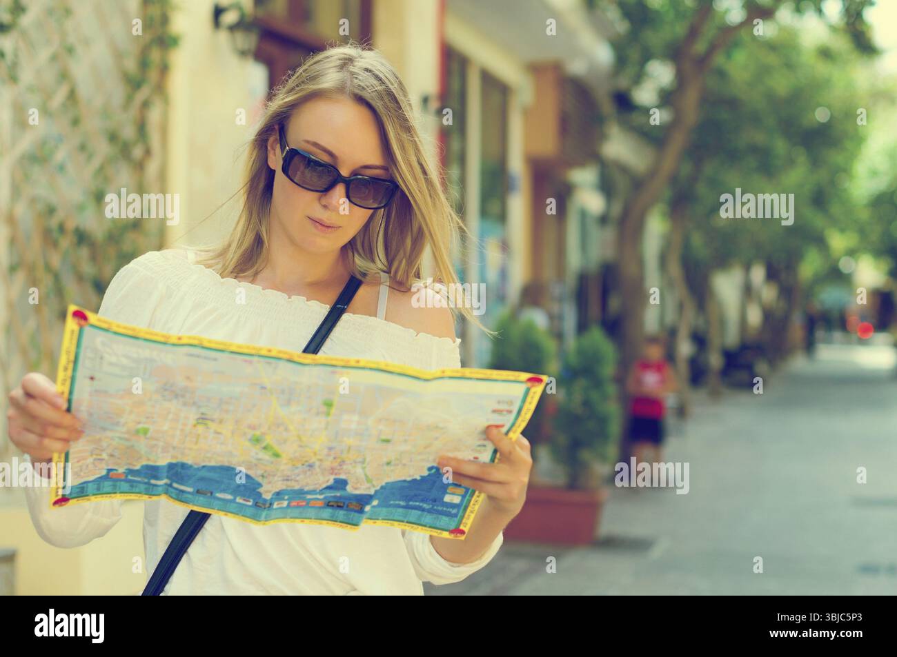 Woman with map in the street. Place for your text Stock Photo - Alamy