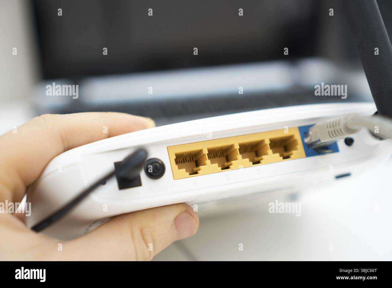 Man holding white wireless router in his hand Stock Photo - Alamy