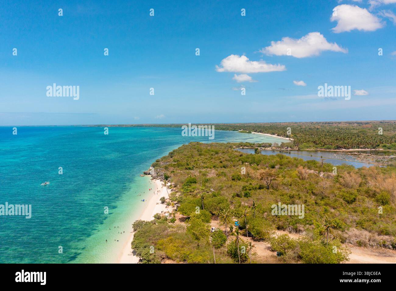Tropical island with coral reefs on turquoise water. White sands and ...