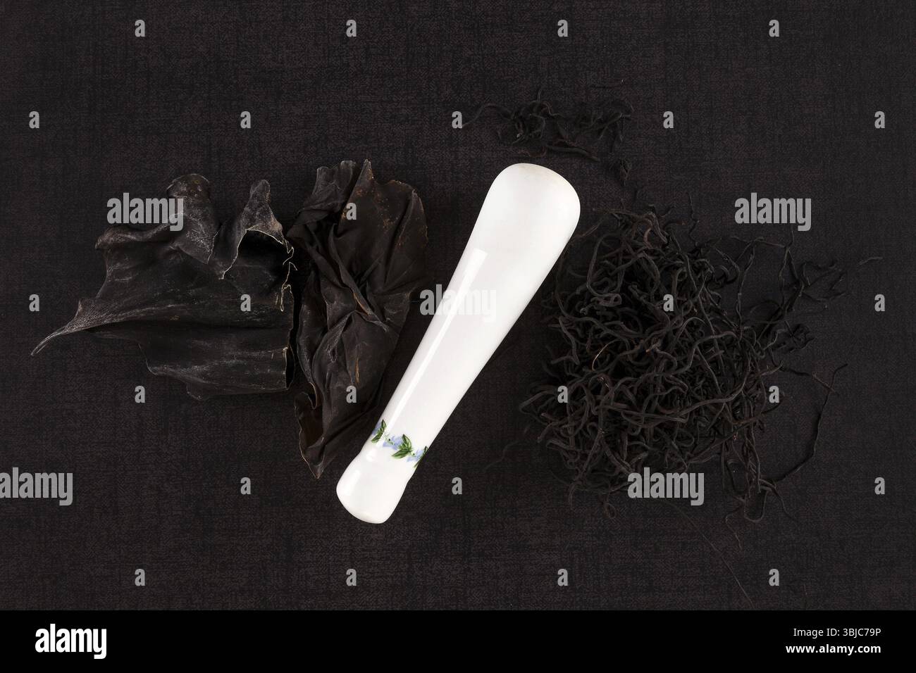 Traditional chinese medicine seaweed and Dan Shen on black background ...