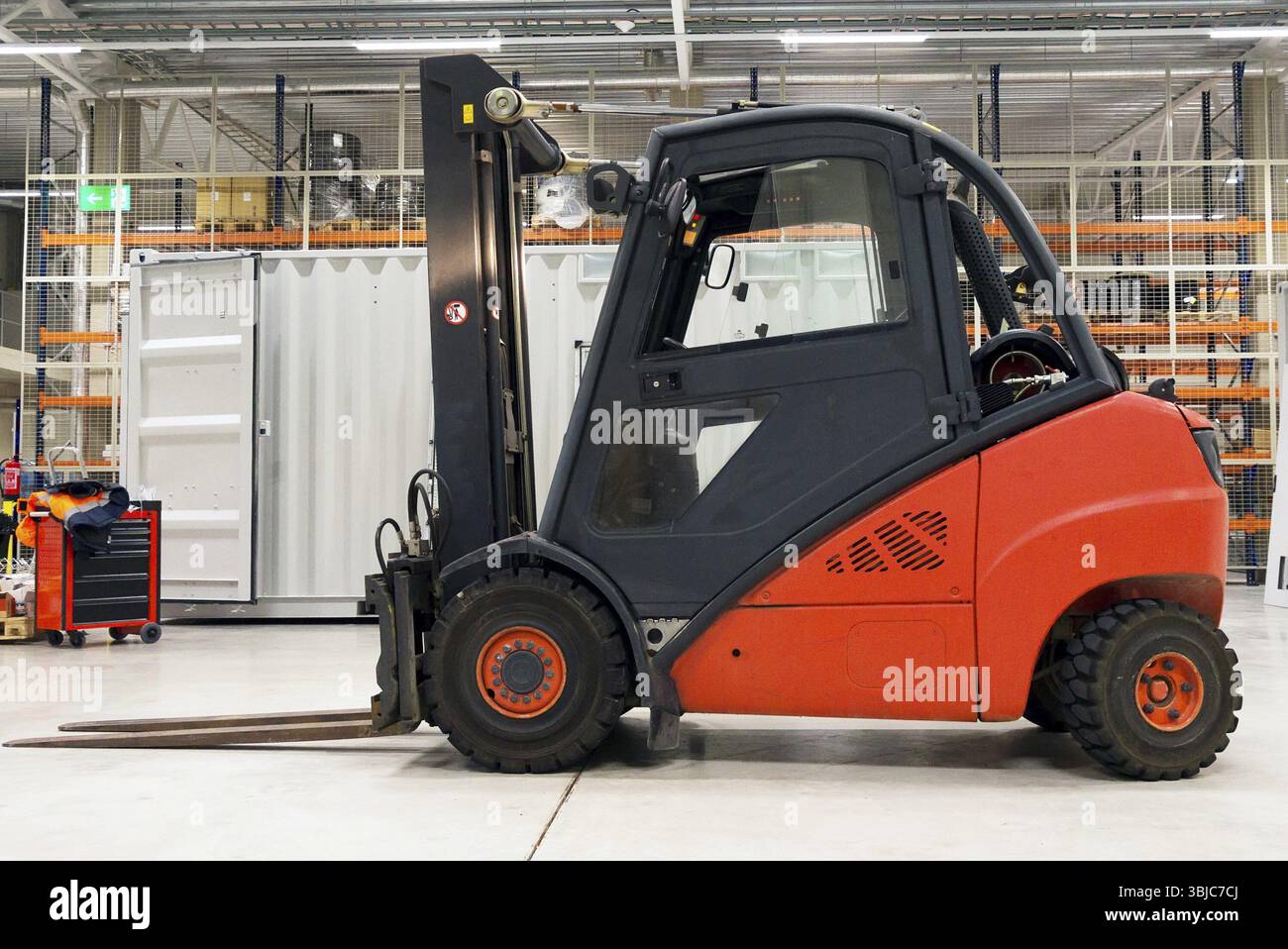 Orange forklift loader in the modern warehouse Stock Photo - Alamy