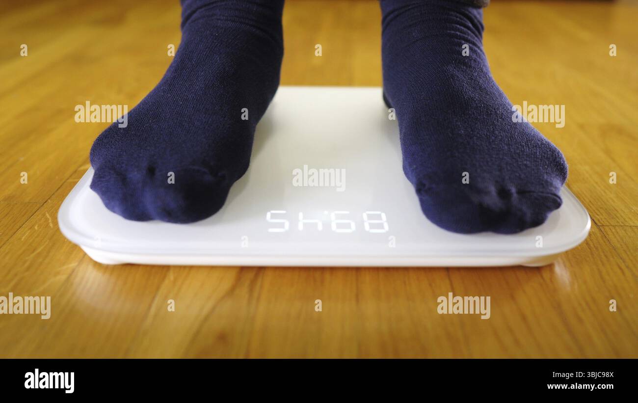 Checking weight on scales hi-res stock photography and images - Alamy