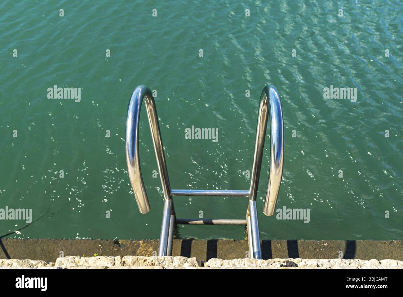 Metal ladder leading into the water Stock Photo - Alamy