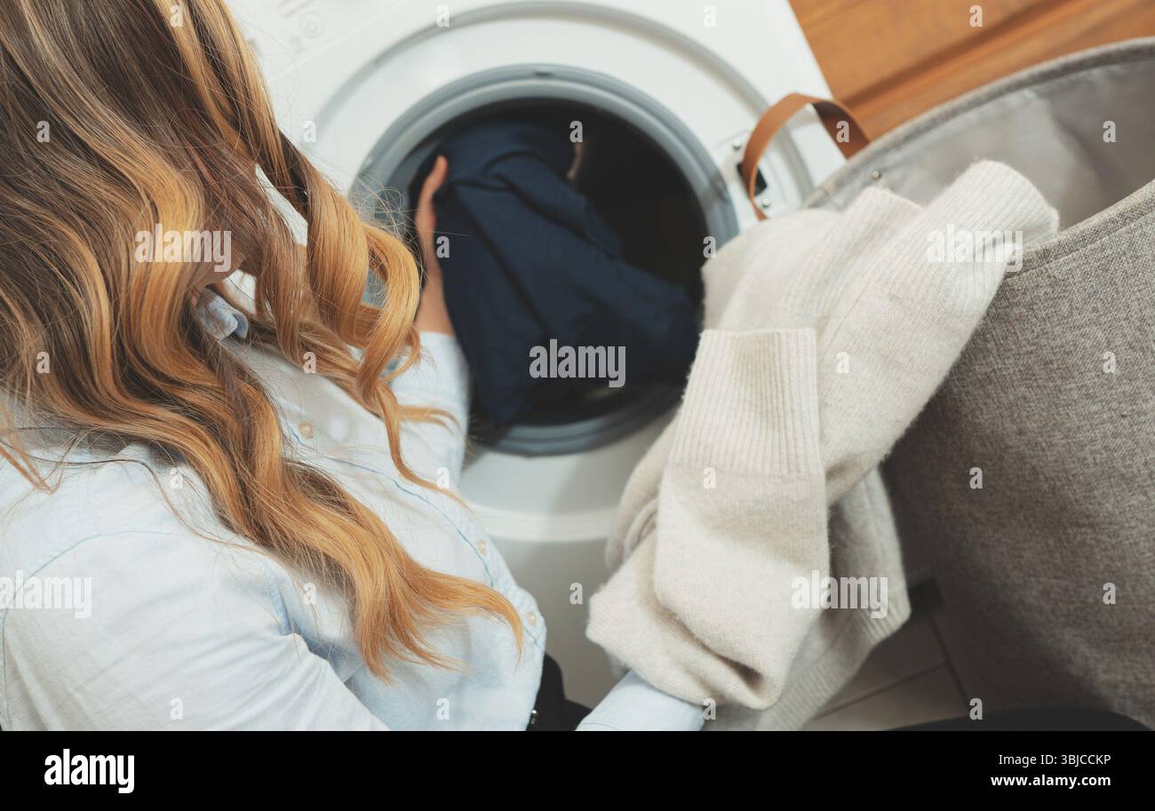 Woman loading washing machine hi-res stock photography and images - Alamy