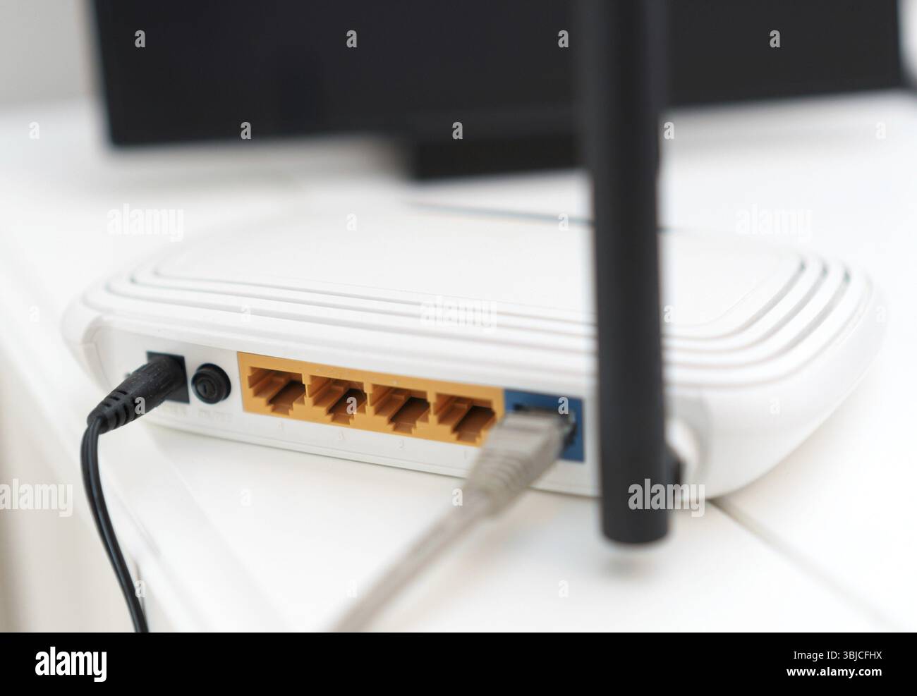 White wireless router standing on the table Stock Photo - Alamy