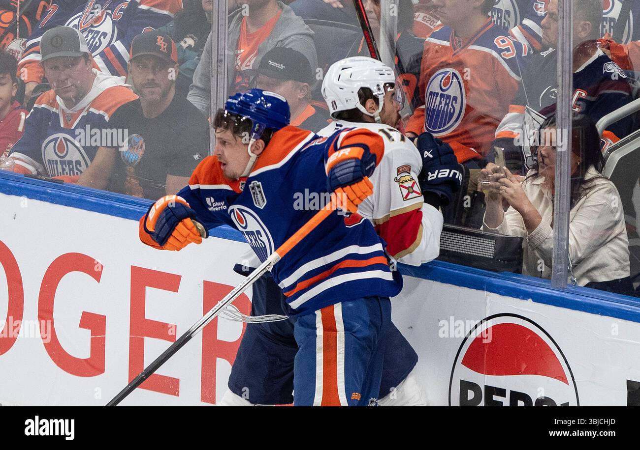 Florida Panthers' Evan Rodrigues (17) is checked by Edmonton Oilers ...