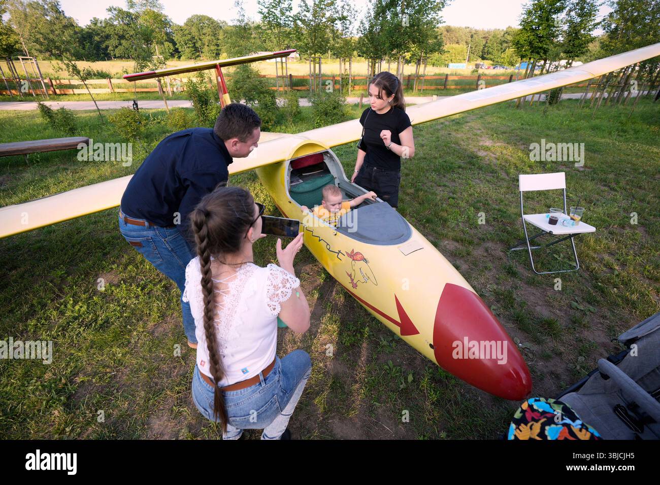 Warsaw. 14th June, 2025. A woman (2nd L) takes photos of a child ...