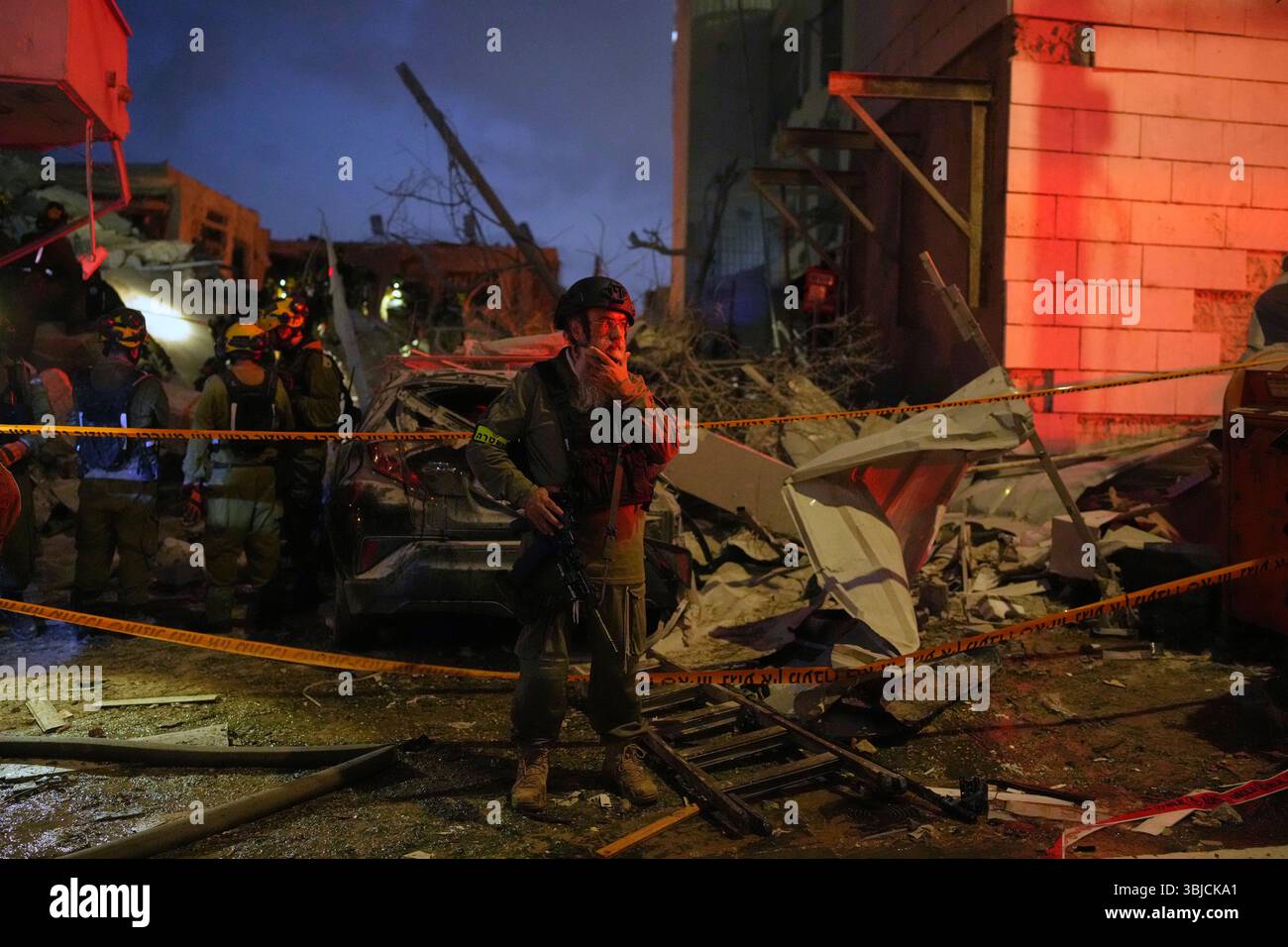 Israeli security forces inspect destroyed buildings that were hit by a ...
