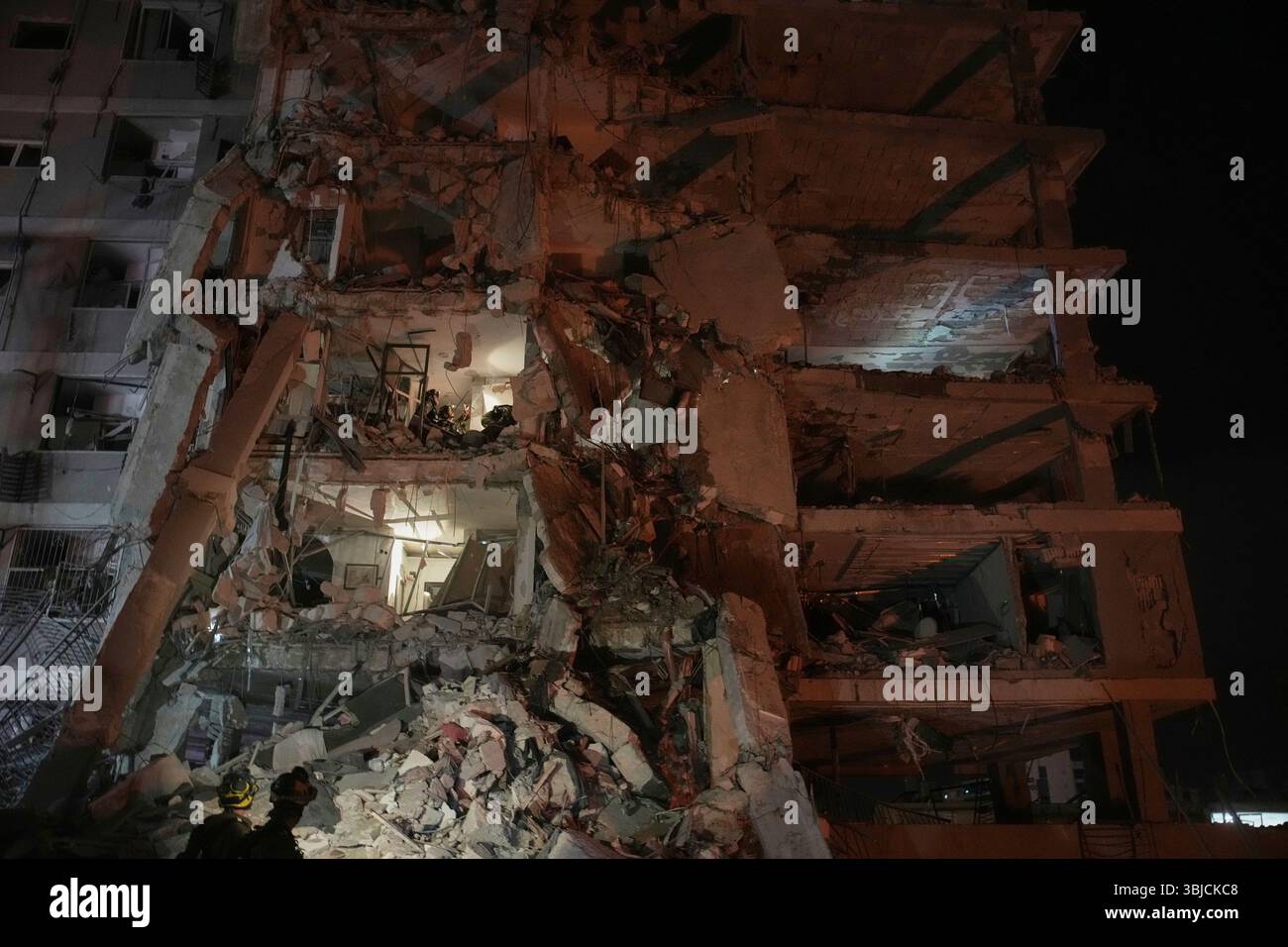 Israeli security forces inspect destroyed buildings that were hit by a ...