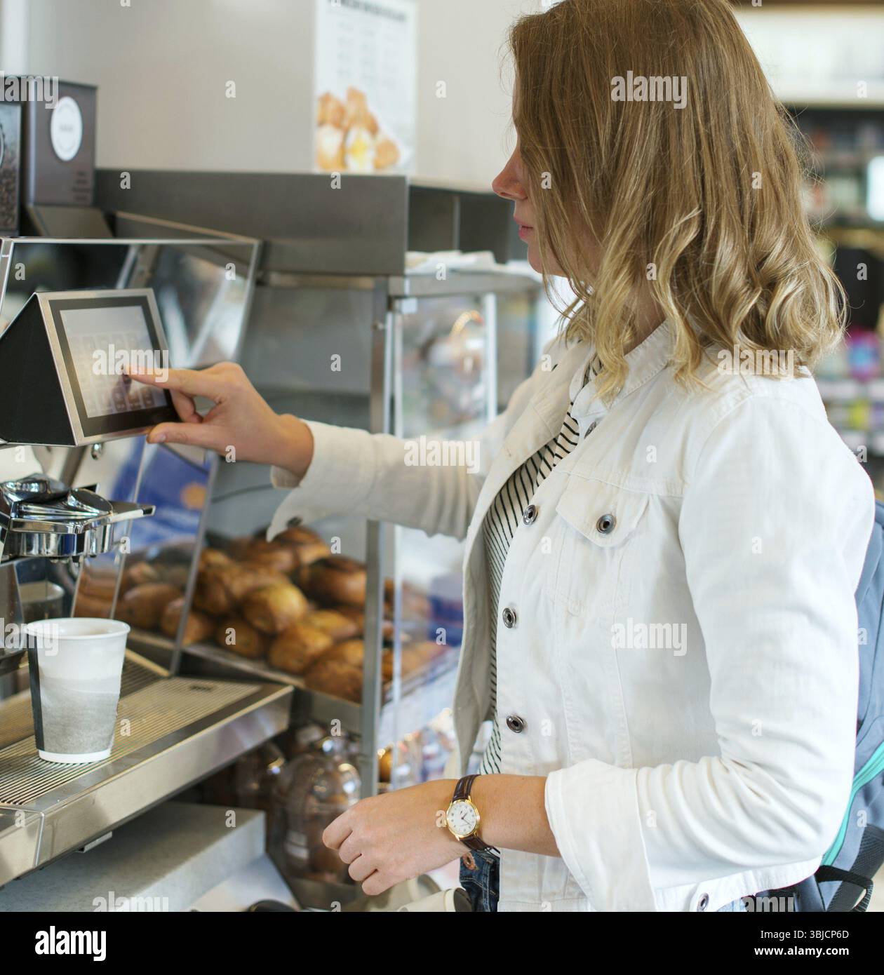 Woman using coffee vending machine hi-res stock photography and images ...