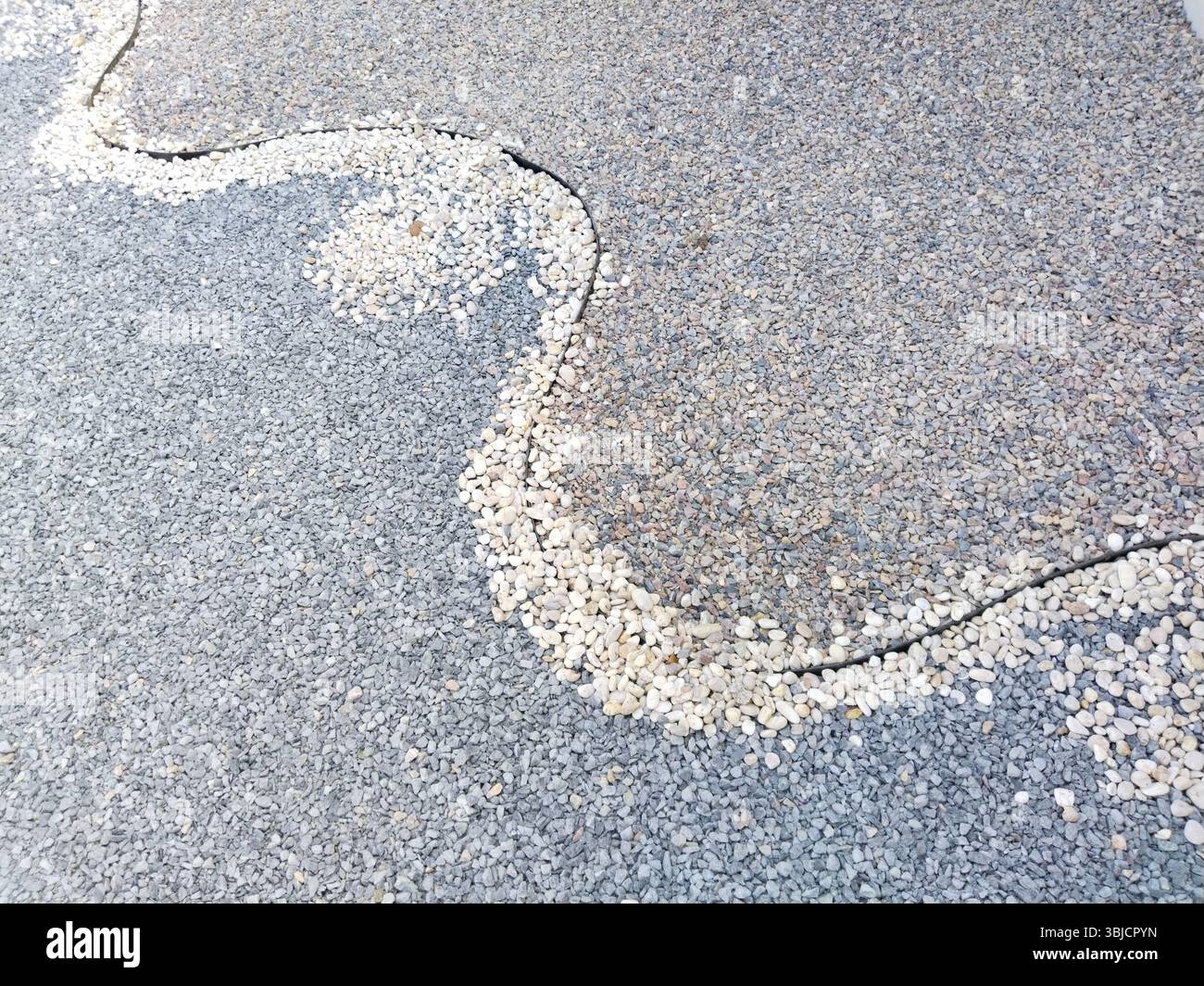 Curvy shape designed pebble ground Stock Photo - Alamy