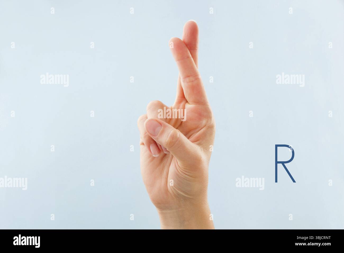 American sign language. Female hand showing letter R isolated on blue ...