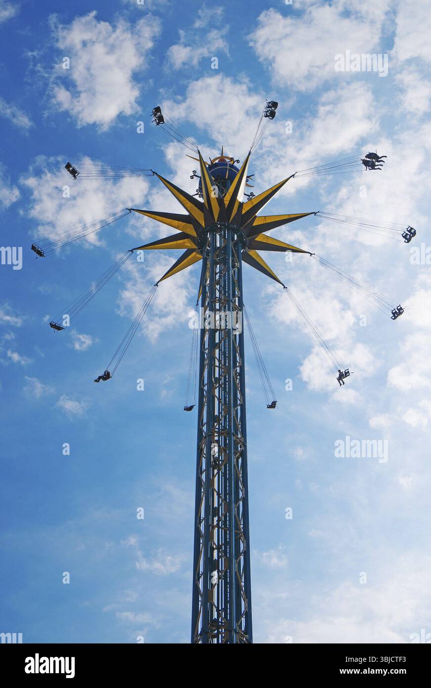 Flying swinging high chained carousel in amusement park Stock Photo - Alamy