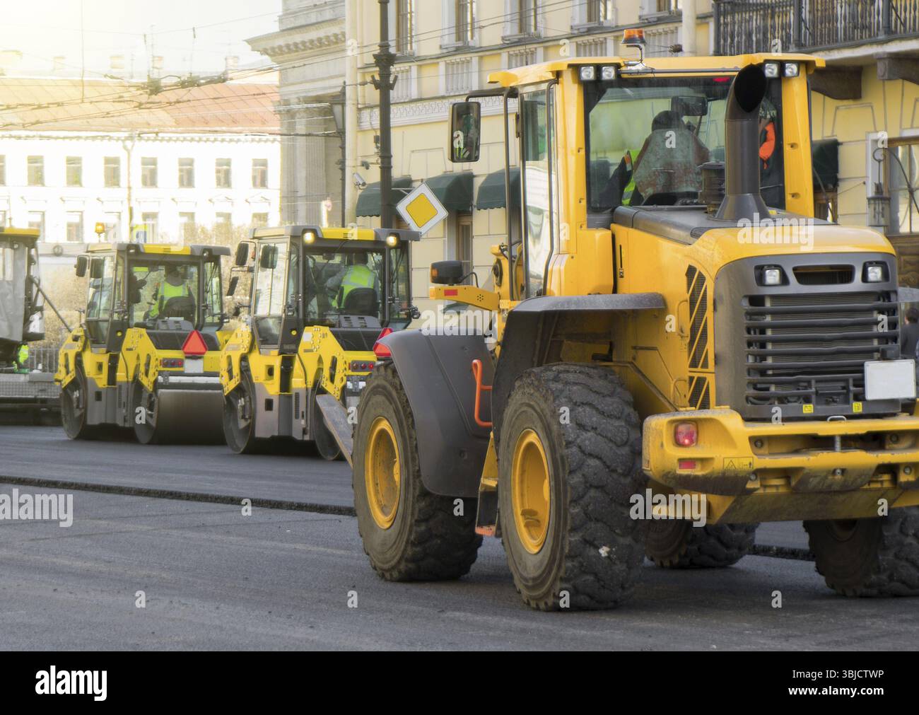 Road re-construction. Road rollers stacking hot asphalt Stock Photo - Alamy