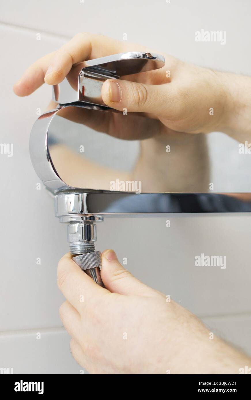 Plumber hands fixing shower mixer on modern water tap Stock Photo - Alamy