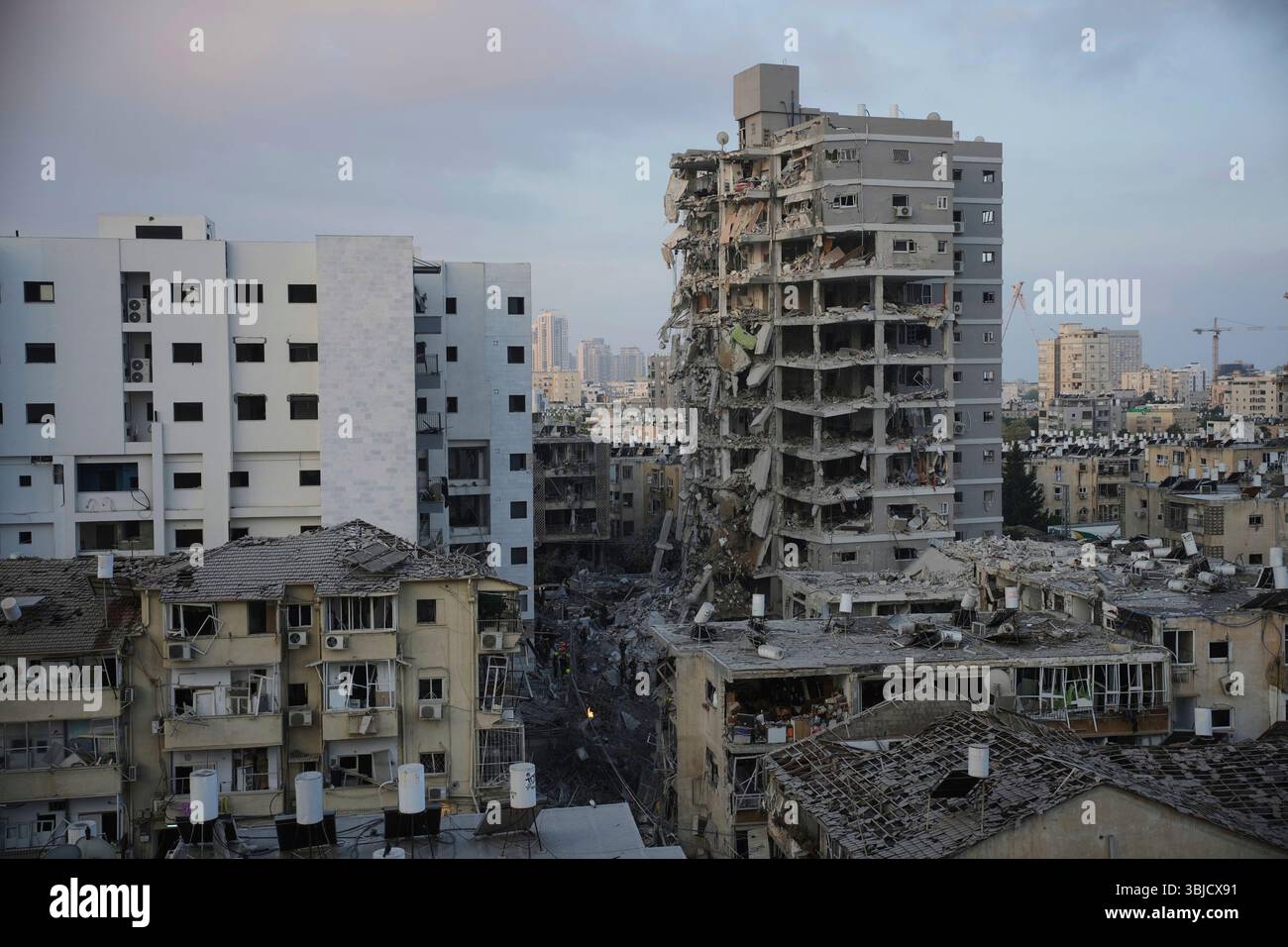 Israeli security forces inspect destroyed buildings that were hit by a ...