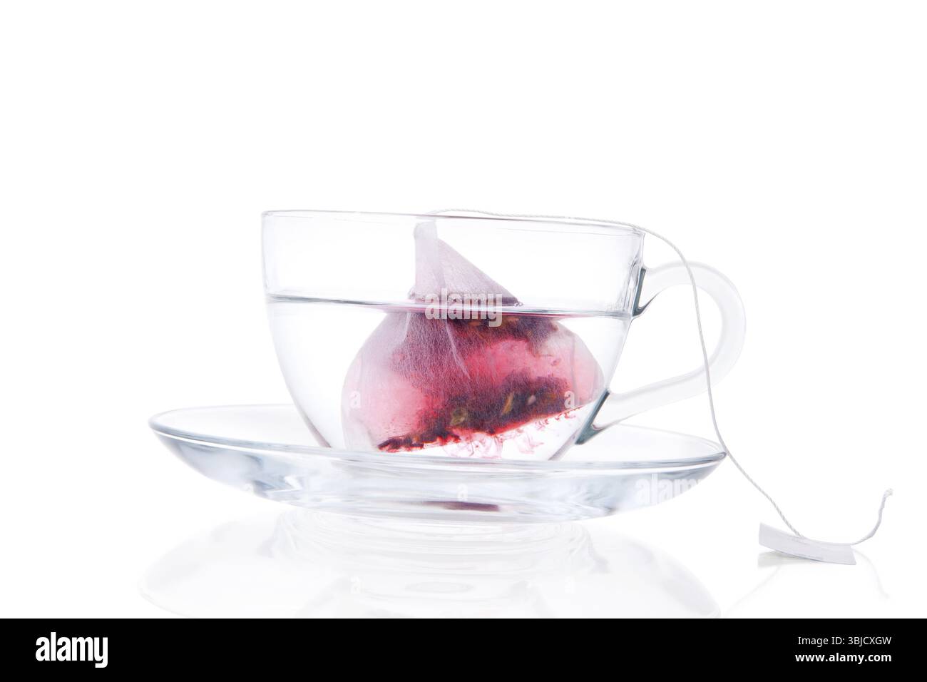 Luxurious tea still life. Tea bag dissolving in transparent tea cup ...