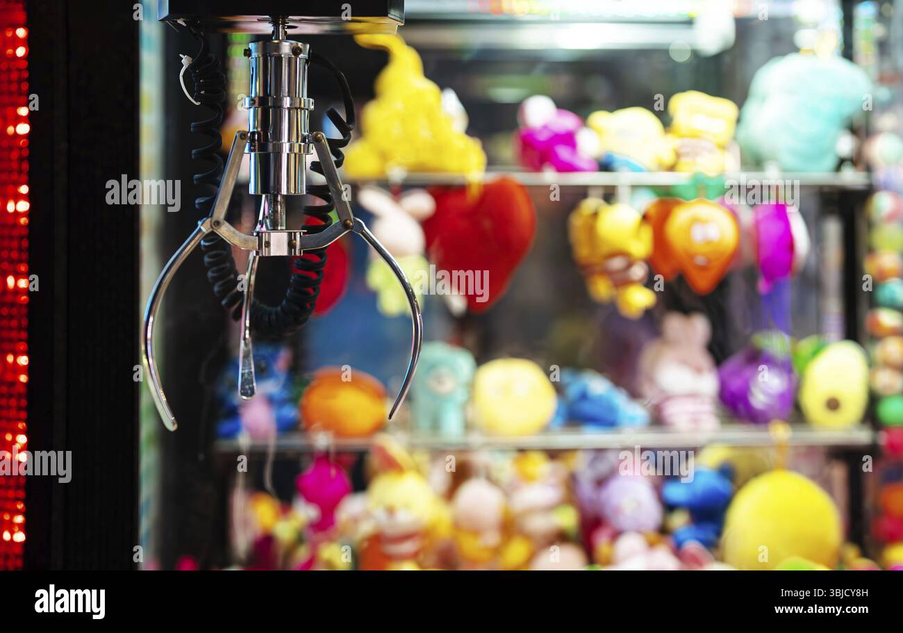 Mechanical claw game machine. Close-up view Stock Photo - Alamy