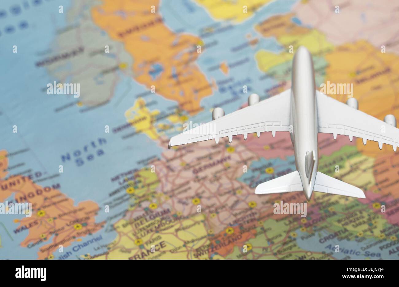 Toy of a plane flying over the Europe map Stock Photo - Alamy