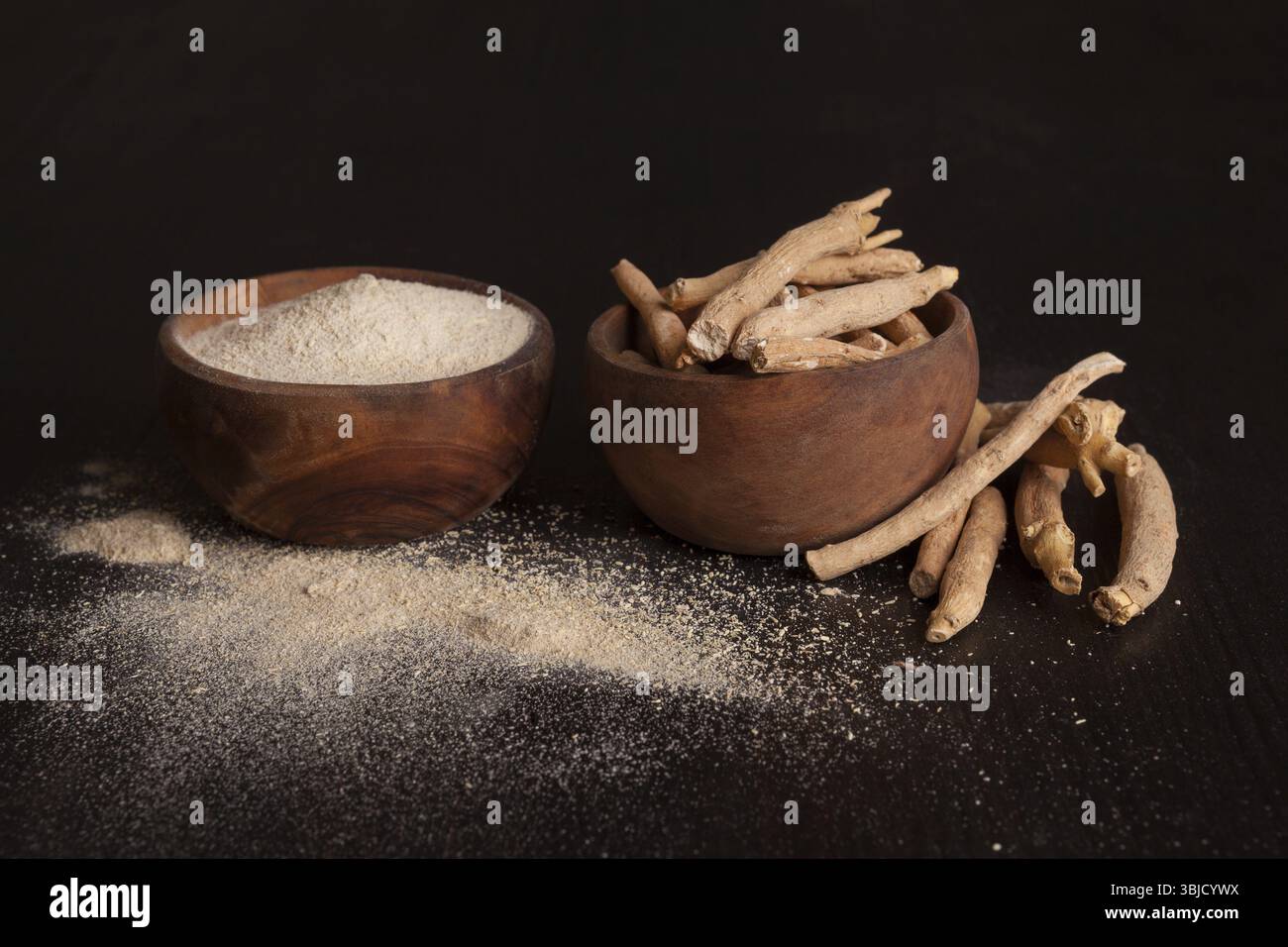 Roots and powder of Ashwagandha also known as Indian ginseng on wooden ...