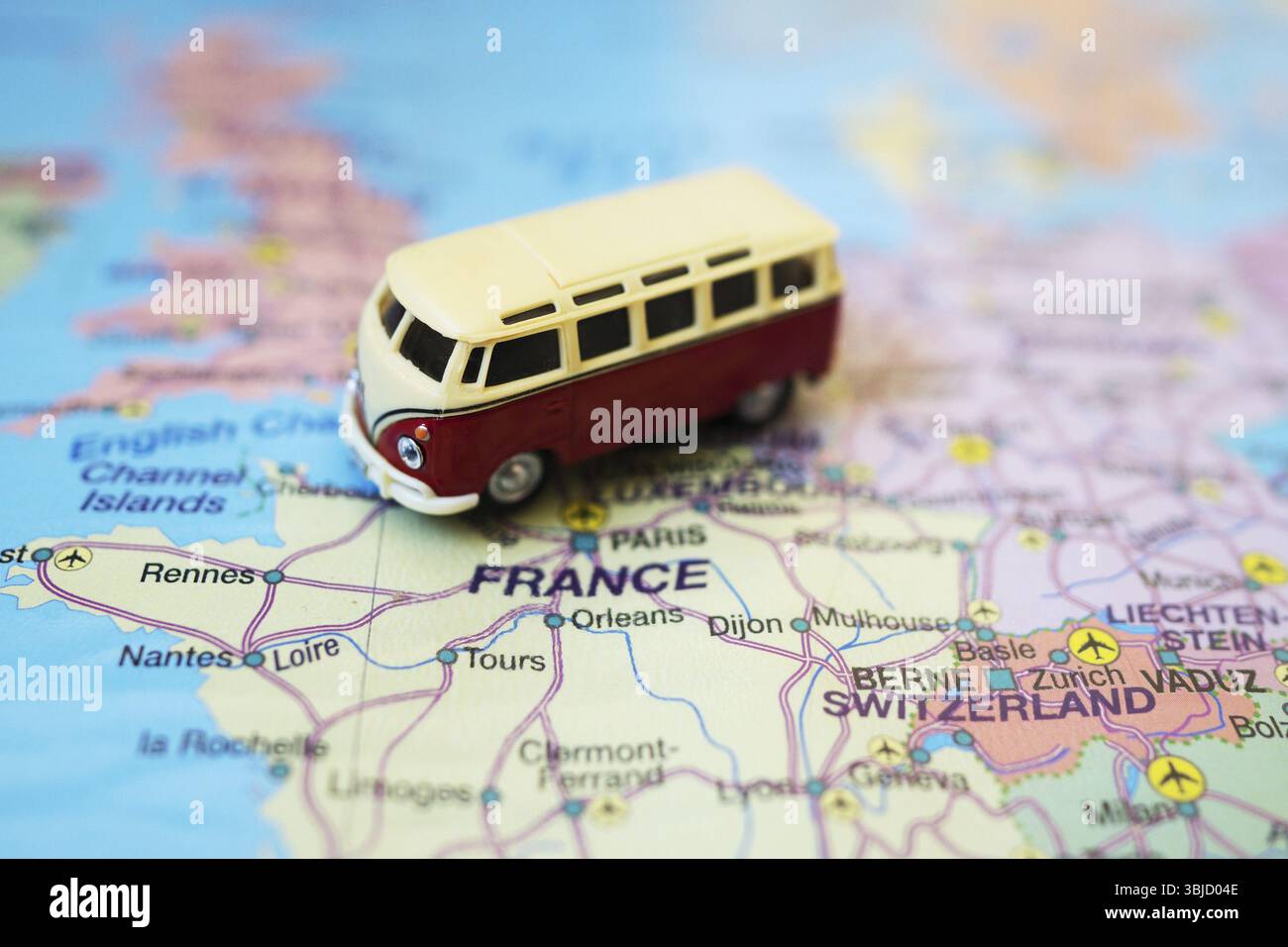 Small toy retro bus on Europe map in France. Travel by minivan concept ...