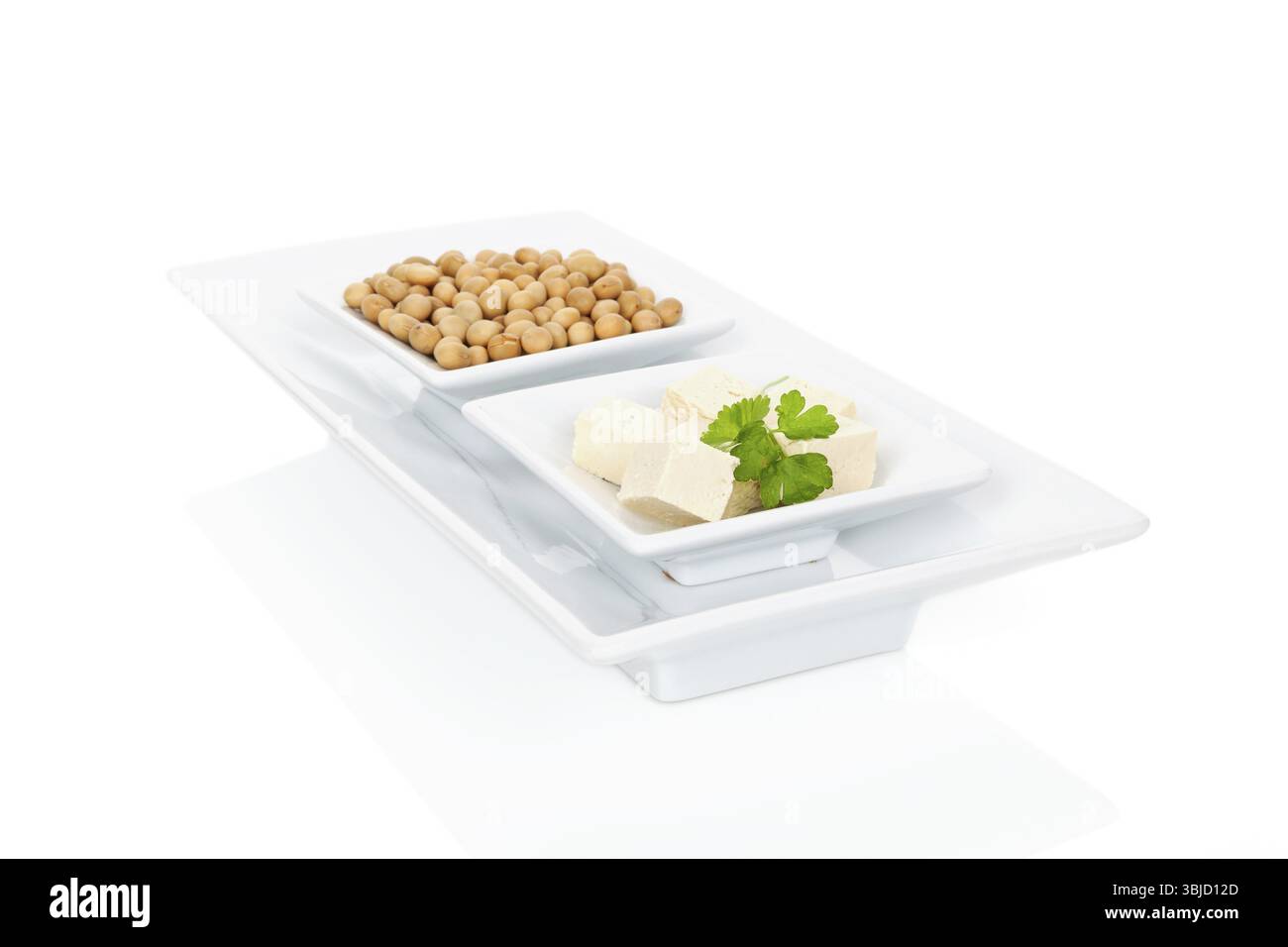 Soybeans and tofu in white bowls isolated on white background. Culinary ...