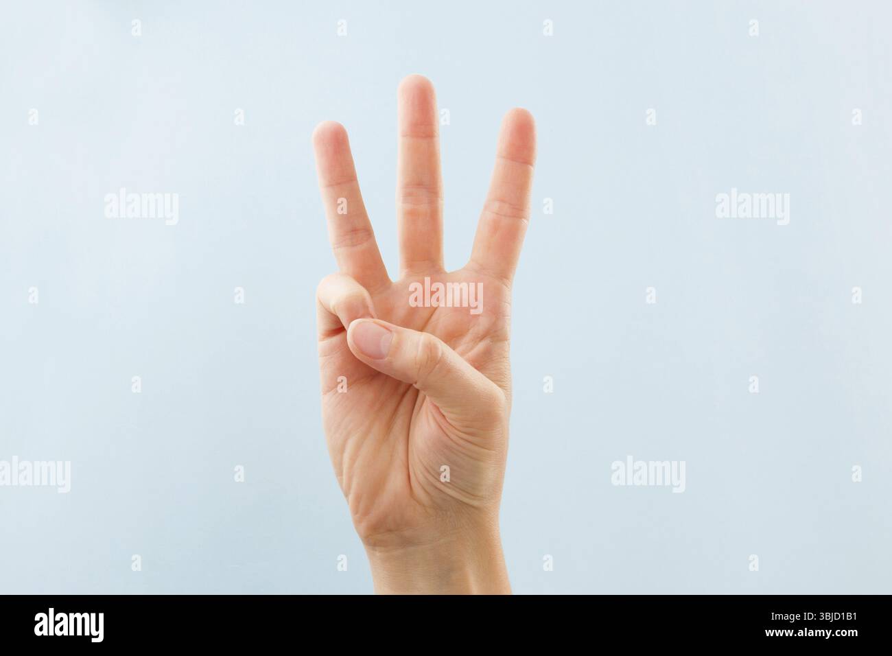 American sign language. Female hand showing letter W isolated on blue ...