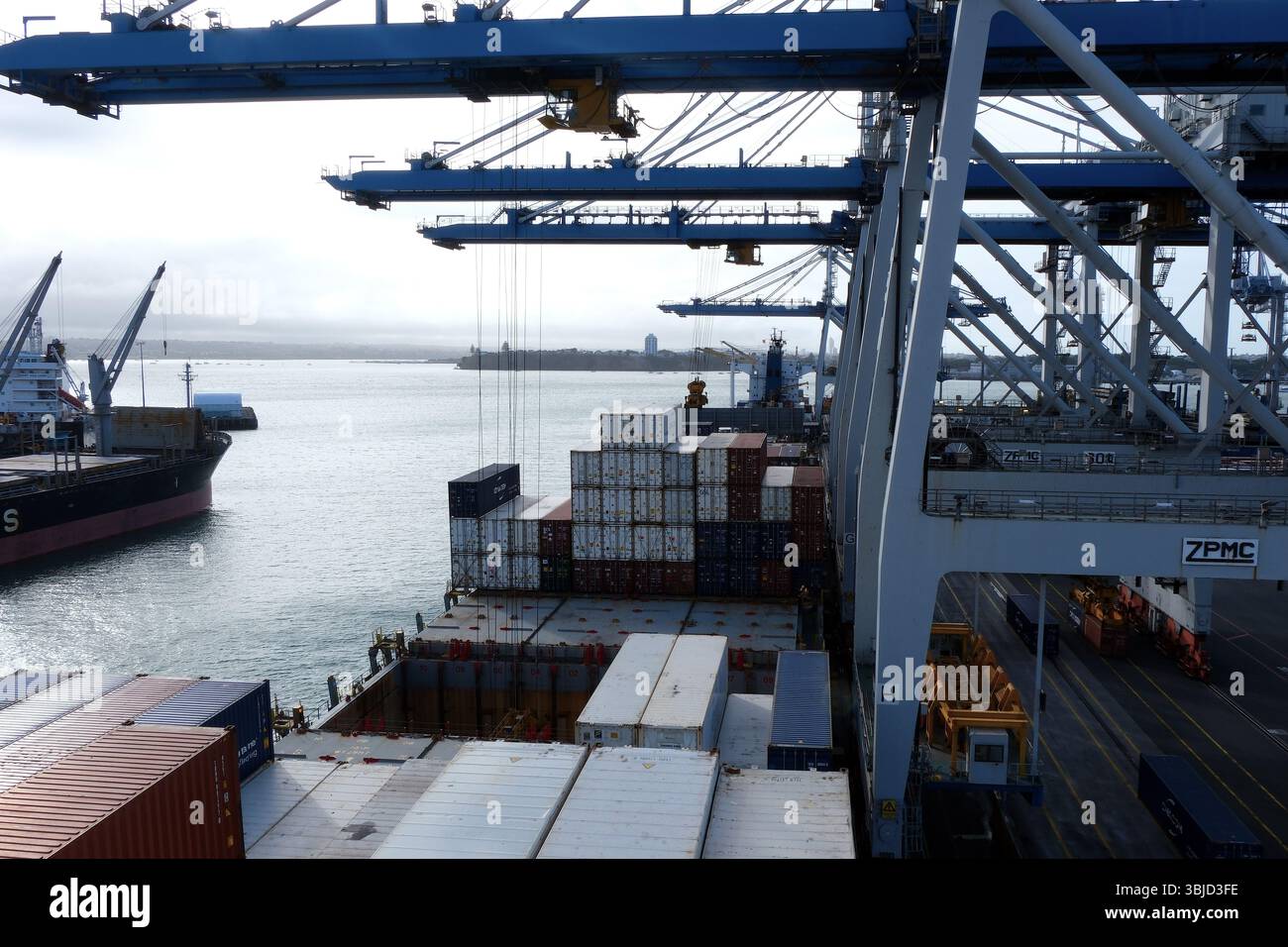 Container ship during cargo operation loading and discharging by gantry ...