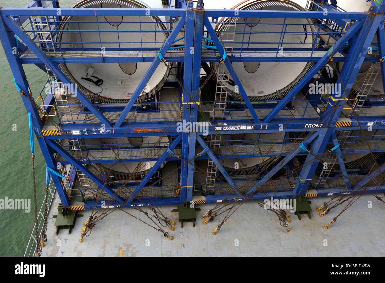 Root ends of long blades of off shore wind turbine loaded and lashed on the heavy load carrier ...