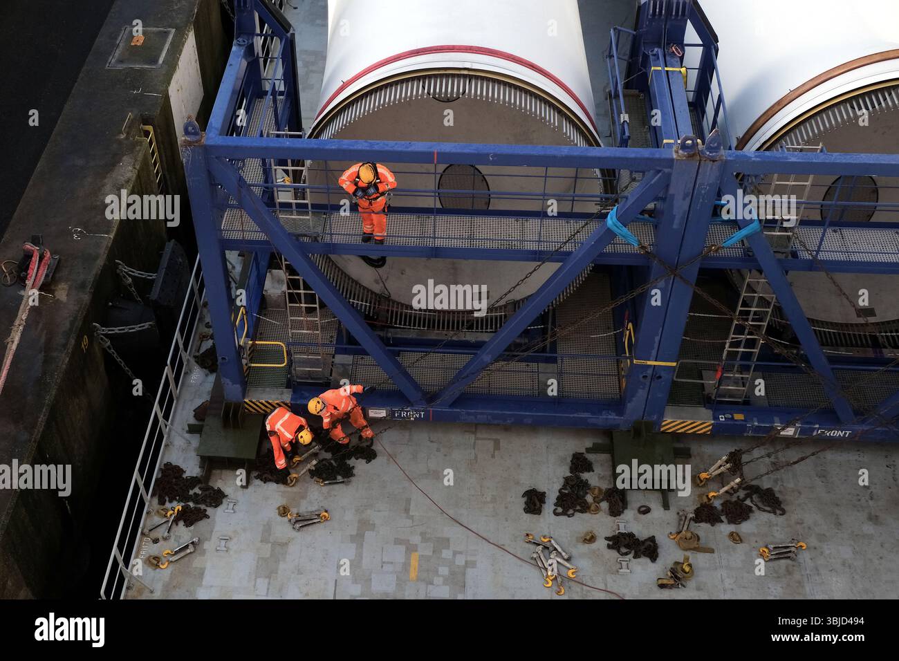 Crew during lashing root ends of long blades of off shore wind turbine ...