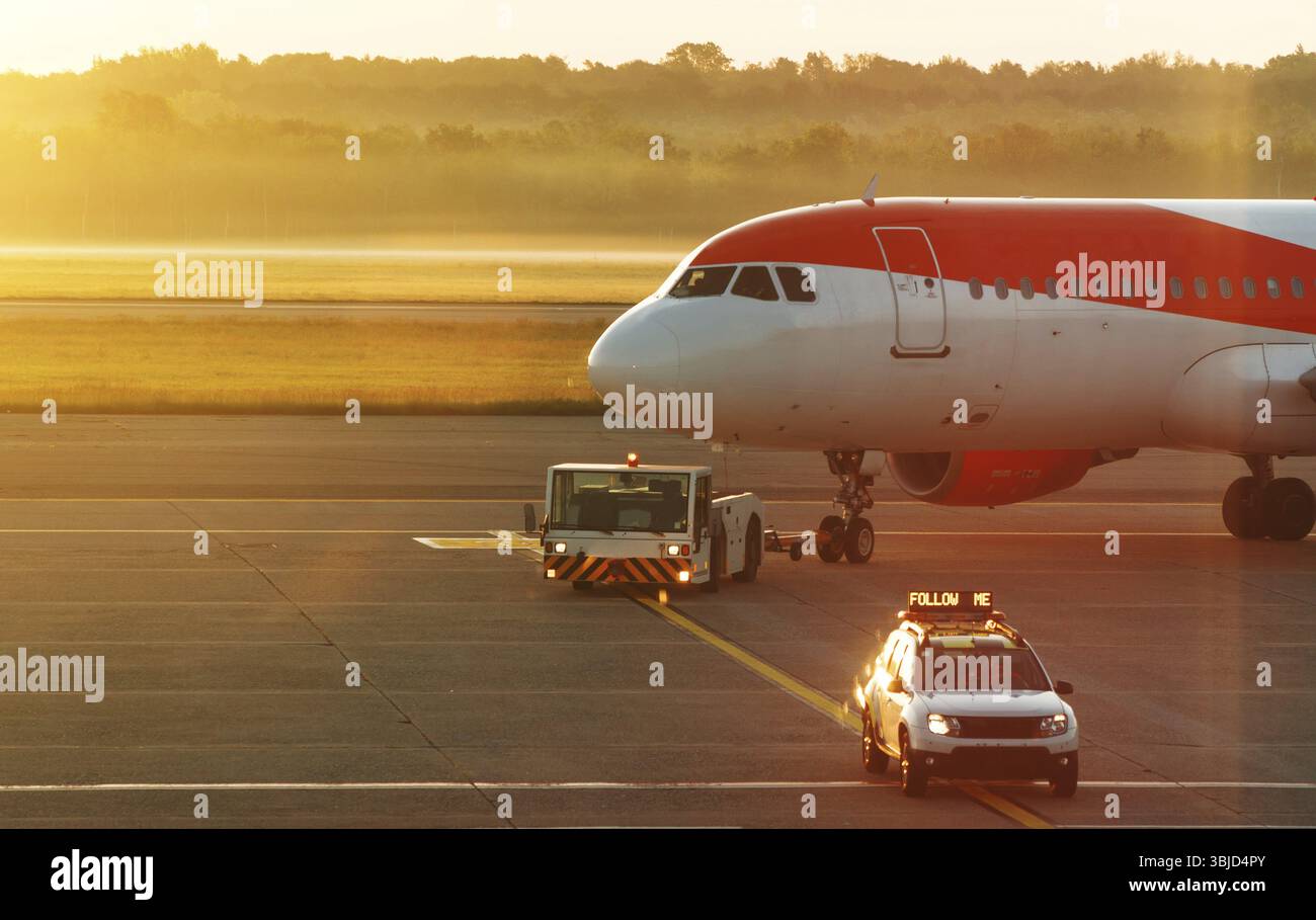 TUG Pushback tractor with Aircraft on the runway in airport Stock Photo ...