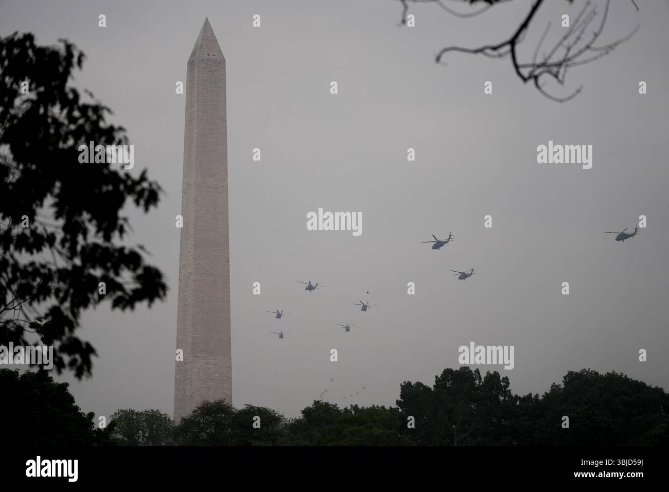 US Army helicopters perform a flyover near the Washington Monument ...