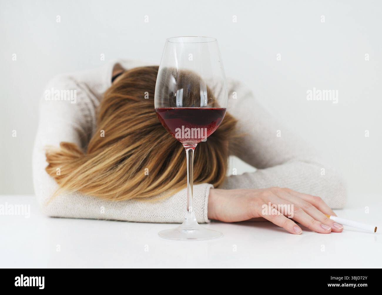 Drunk woman sleeping on the table. Female alcoholism Stock Photo - Alamy