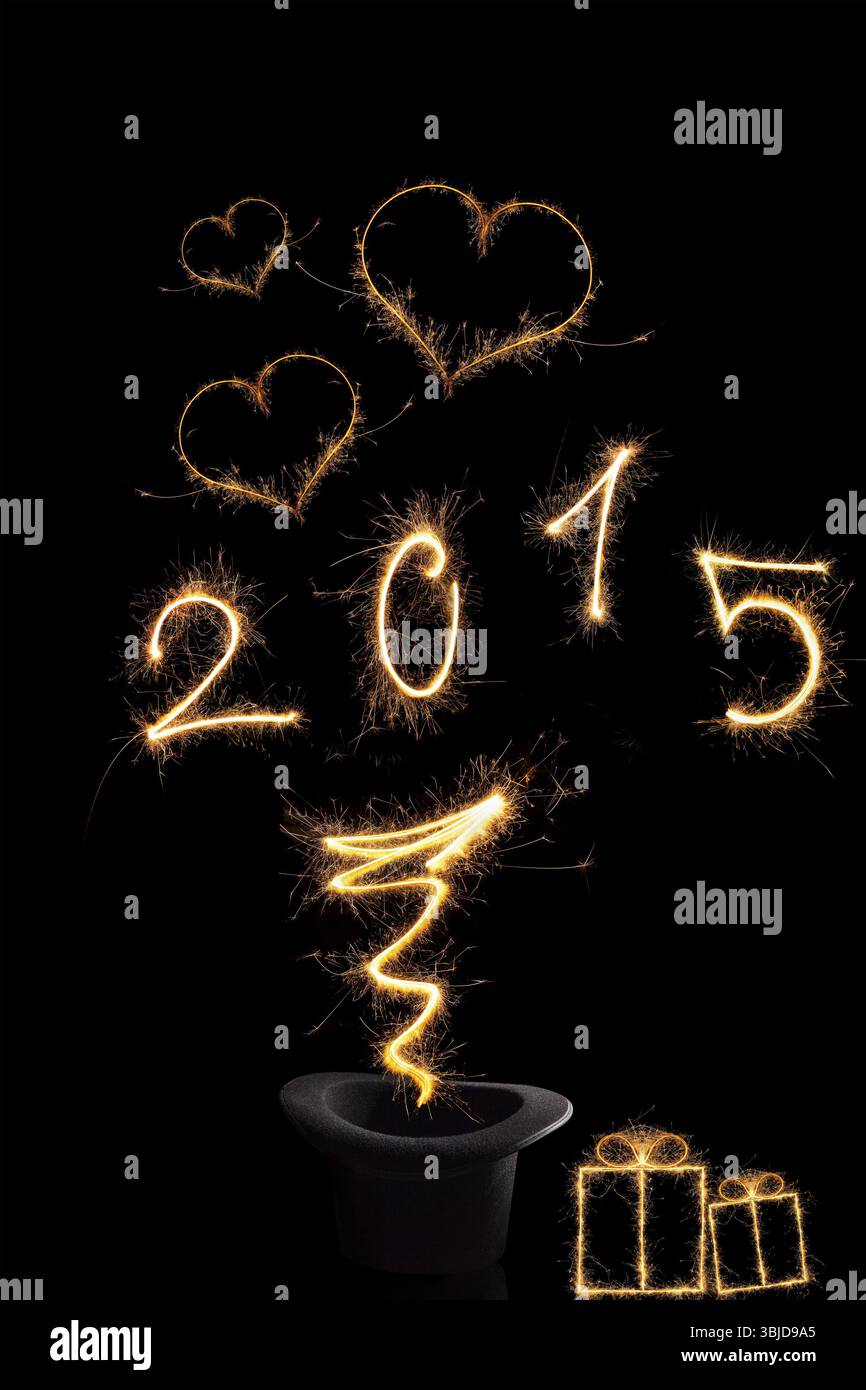 Magical new year. Magical fireworks from black top hat forming 2015 and ...